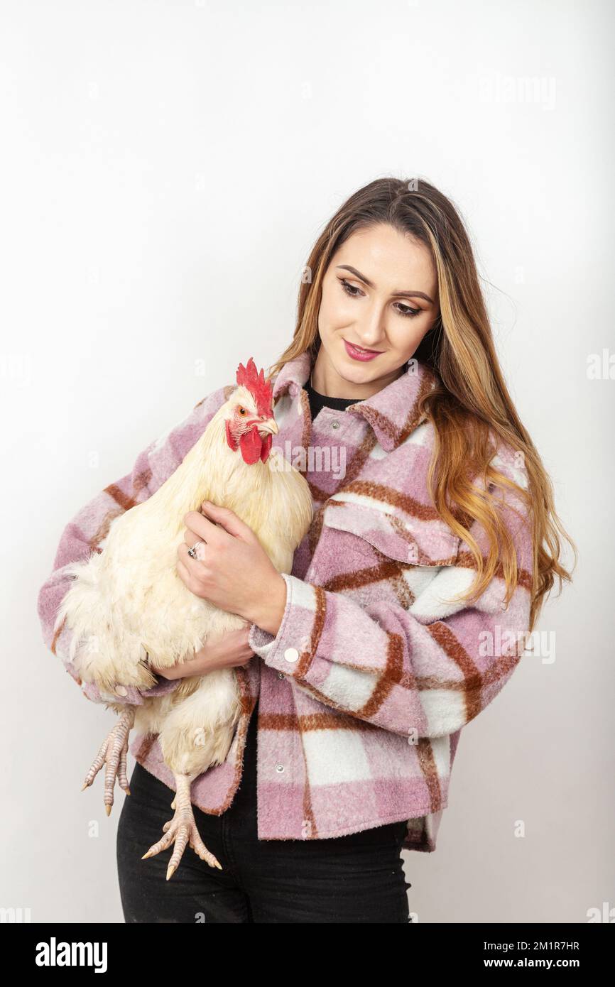 Woman holding a rooster hi-res stock photography and images - Alamy