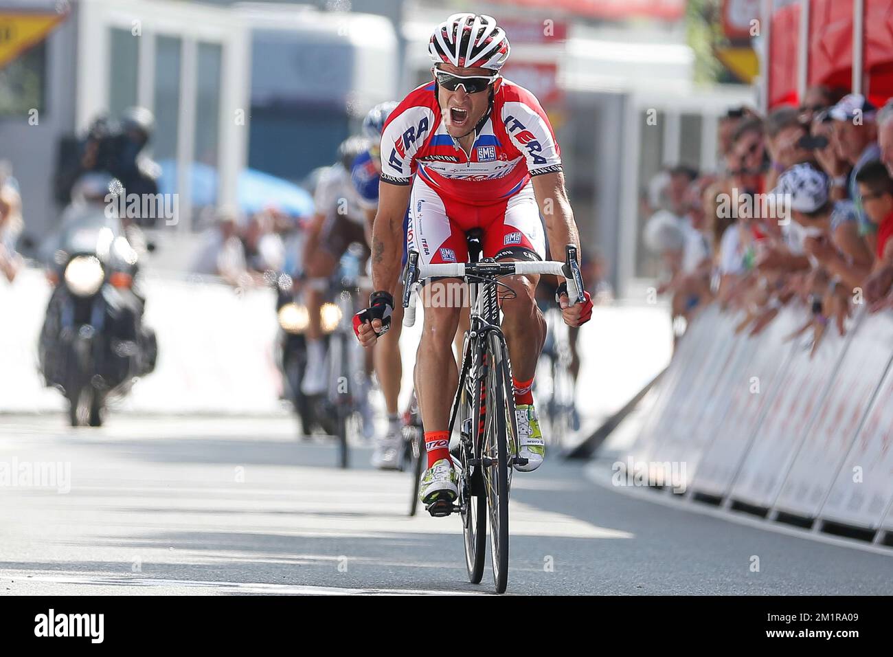 Russian Alexander Kolobnev of Team Katusha celebrates as he crosses the ... Russian Alexander Kolobnev of Team Katusha celebrates as he crosses the ...