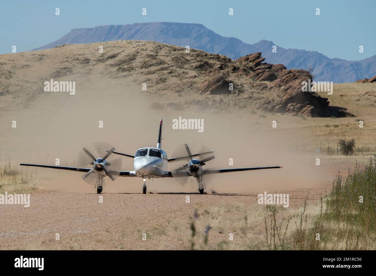 A twin engined Cessna Conquest aircraft taking off from a desert ...