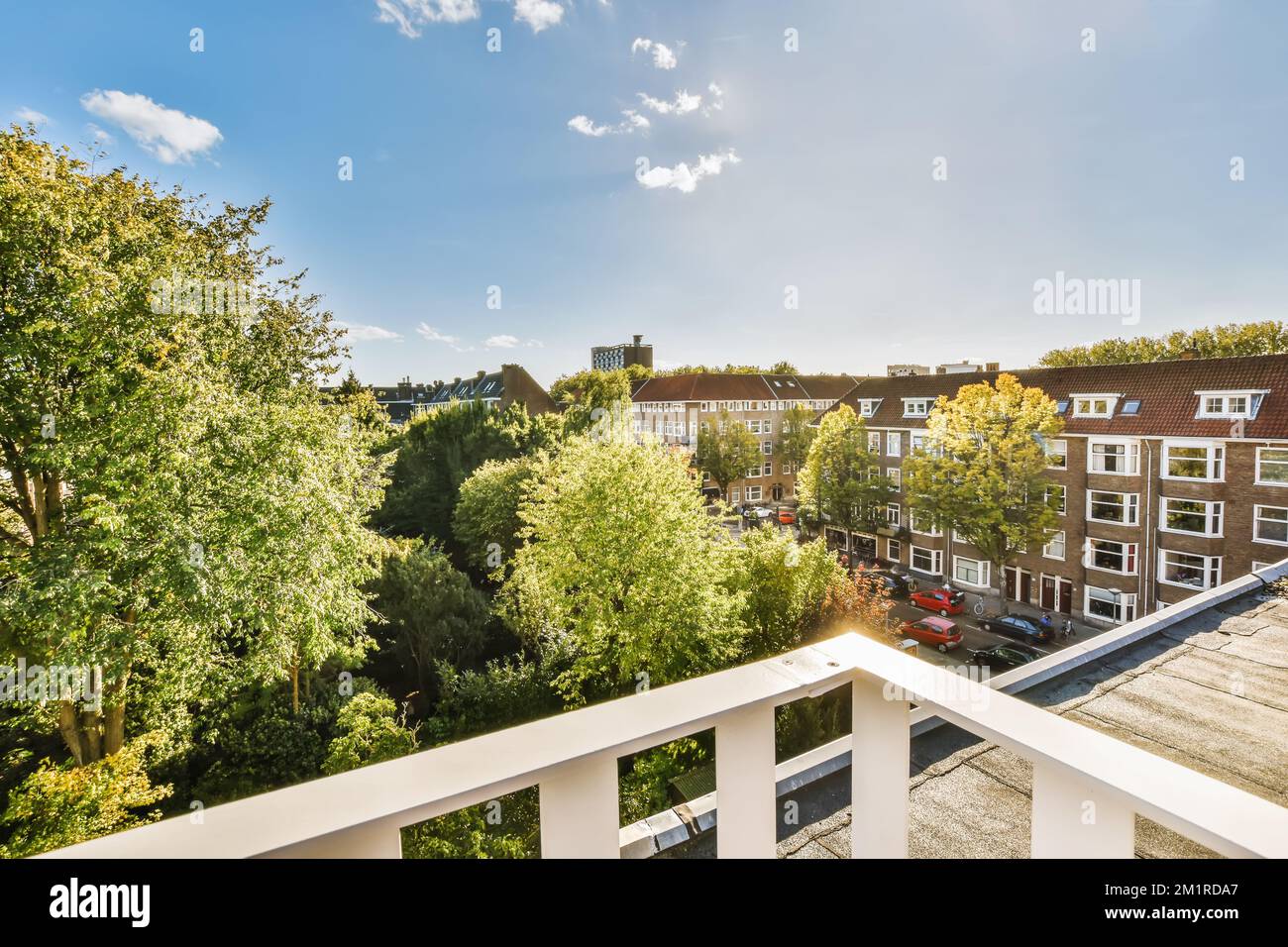 a balcony with trees and houses in the background, taken from an ...