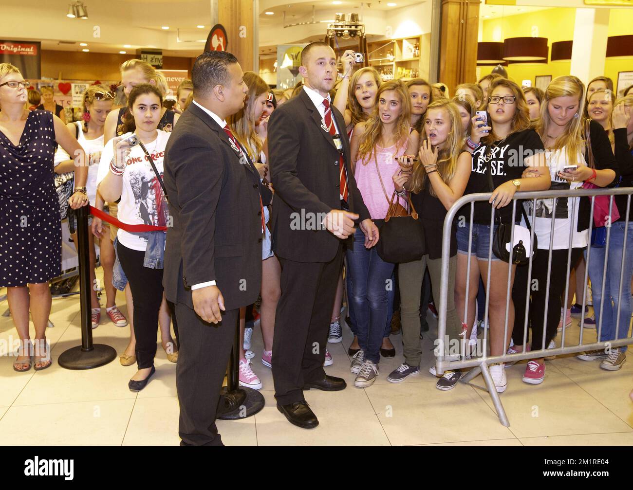 Mall security manages fans during the opening of a temporary store ...