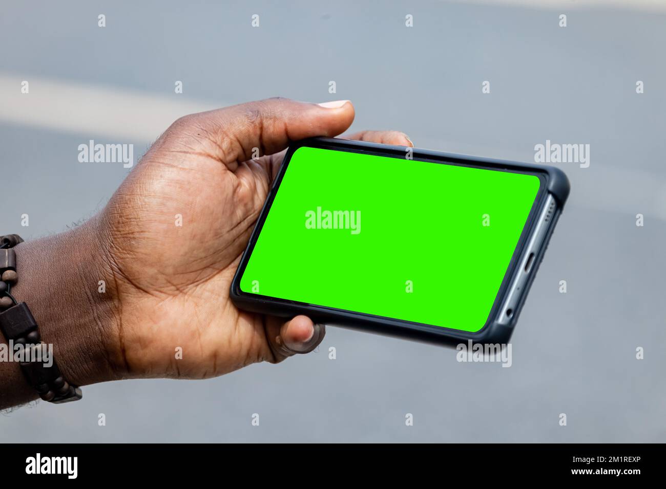 black african hand holding and using blank screen mobile phone ...