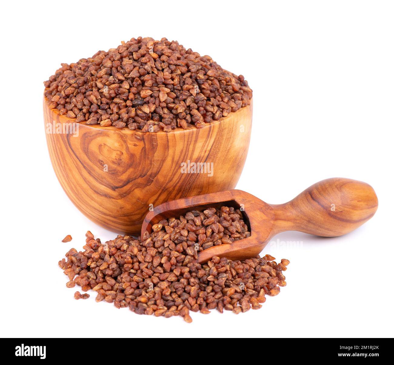 Buckwheat tea in wooden bowl and spoon, isolated on white background ...