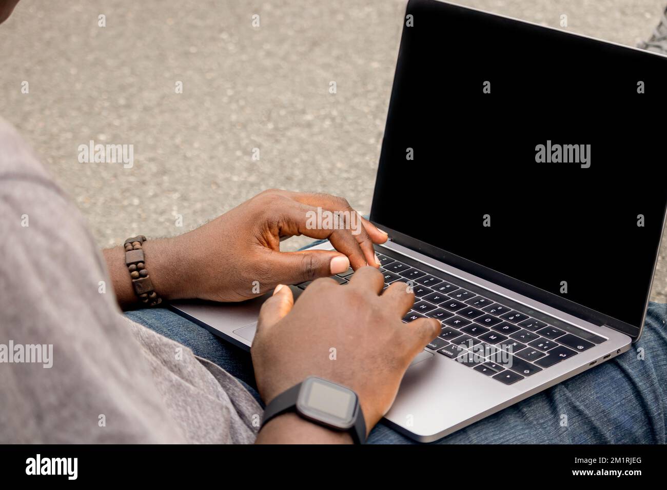 Hand portrait of an African web developer working with his laptop, with ...