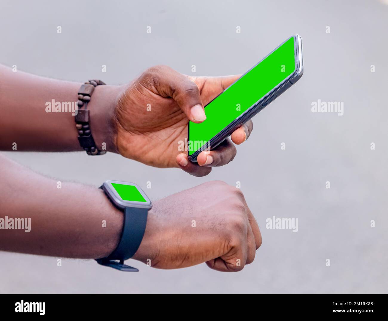 African black man pointing finger at smart phone in city , texting on ...