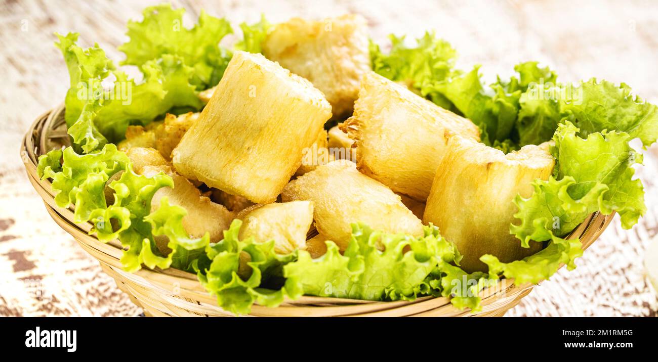 fried cassava with vegetables and sauces, a typical Brazilian snack ...