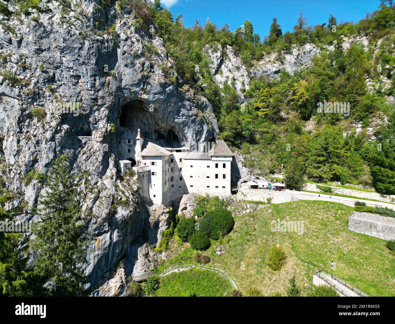 Predjama Castle Slovenia fortress built into cave, Aerial drone summer ...