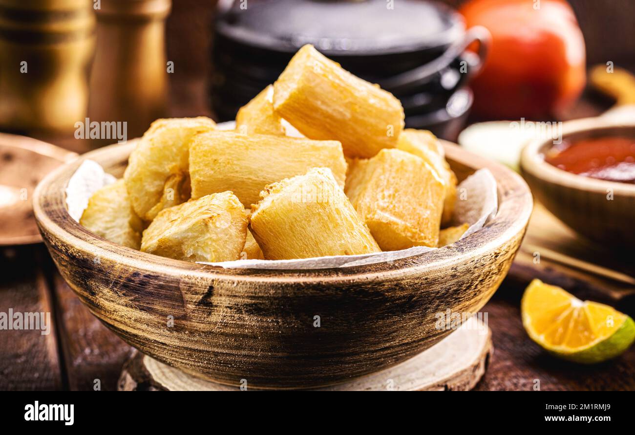large portion of fried cassava, in a rustic rural setting, typical food ...