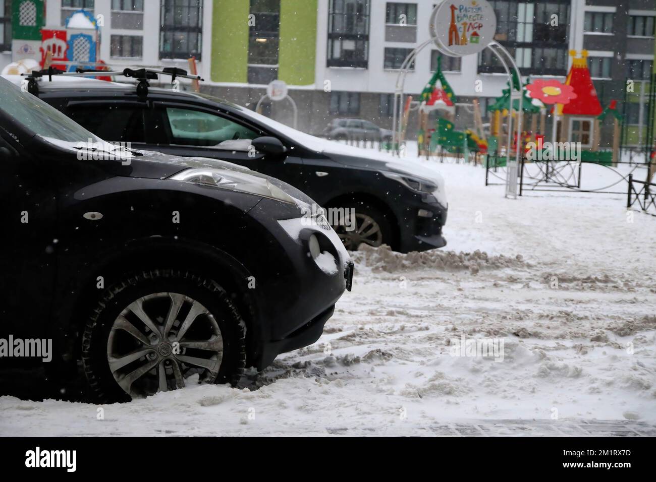 Cars got stuck in the snow in the courtyard of an apartment after a ...