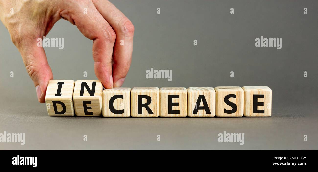 Increase or decrease symbol. Concept words Increase and Decrease on wooden cubes. Businessman ...