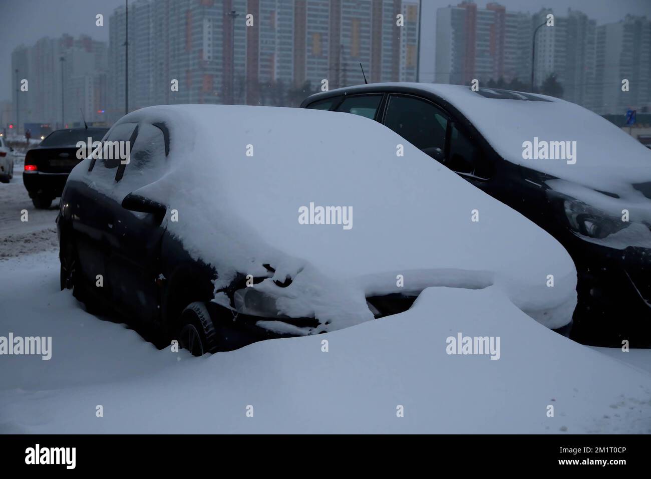 A car seen covered with snow during a heavy snowfall and blizzard ...