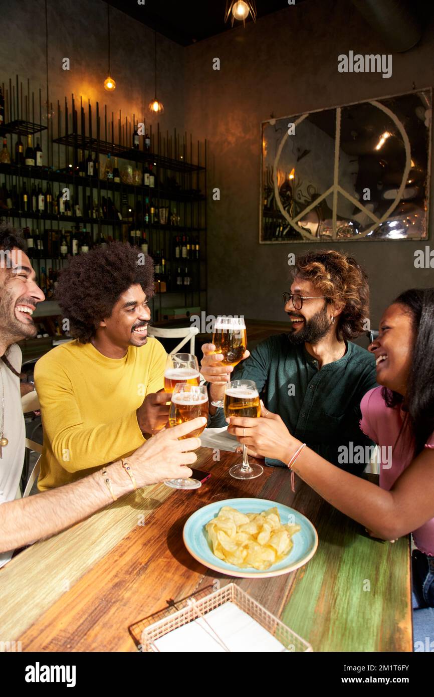 Vertical portrait of a Group of colleague workers toast with beer in ...