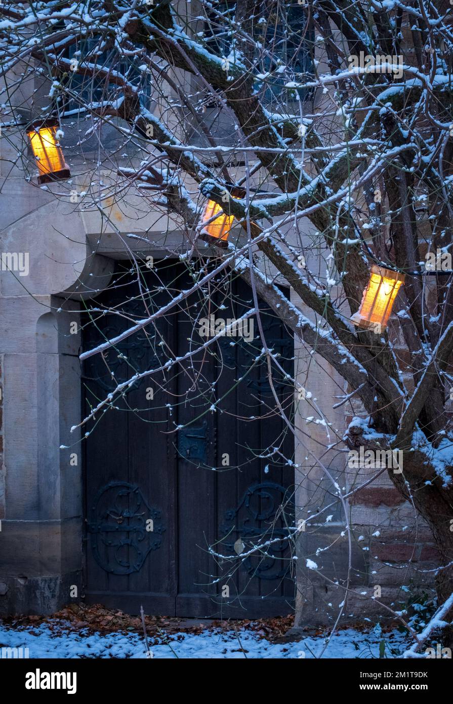 Lanterns by church entrance in snow, Wernigerode, Germany Stock Photo ...
