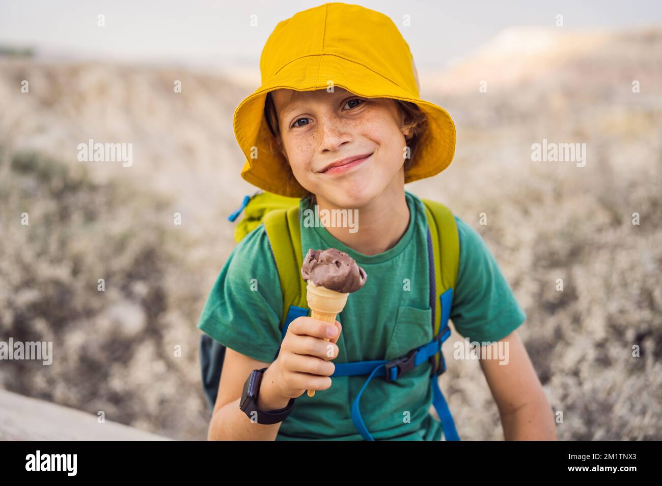 Boy tourist boy eating turkish ice cream while exploring valley with ...