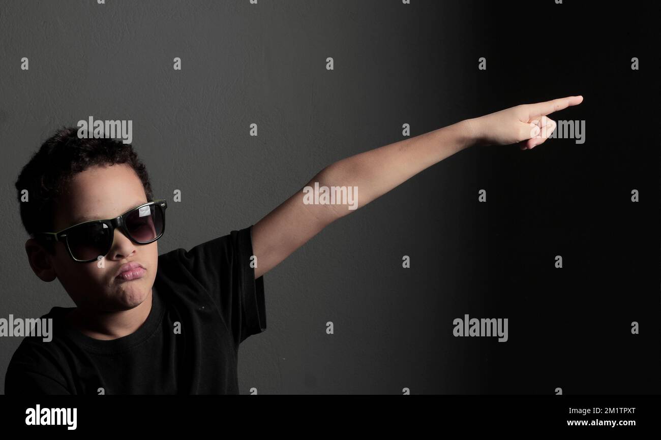 child pointing and reaching up to the sky on white background with ...
