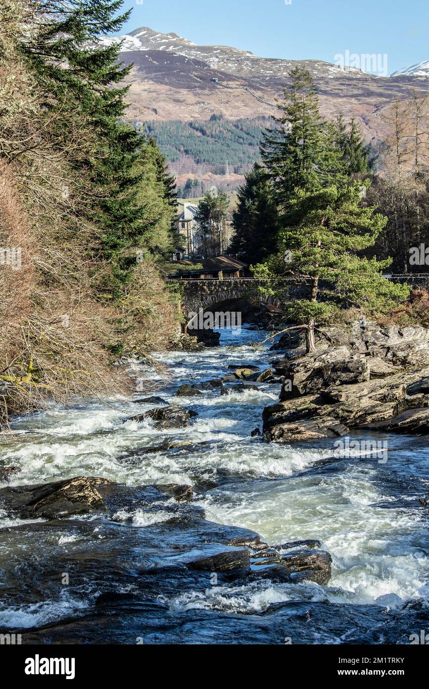 Portrait: Falls of Dochart looking downstream towards the bridge ...