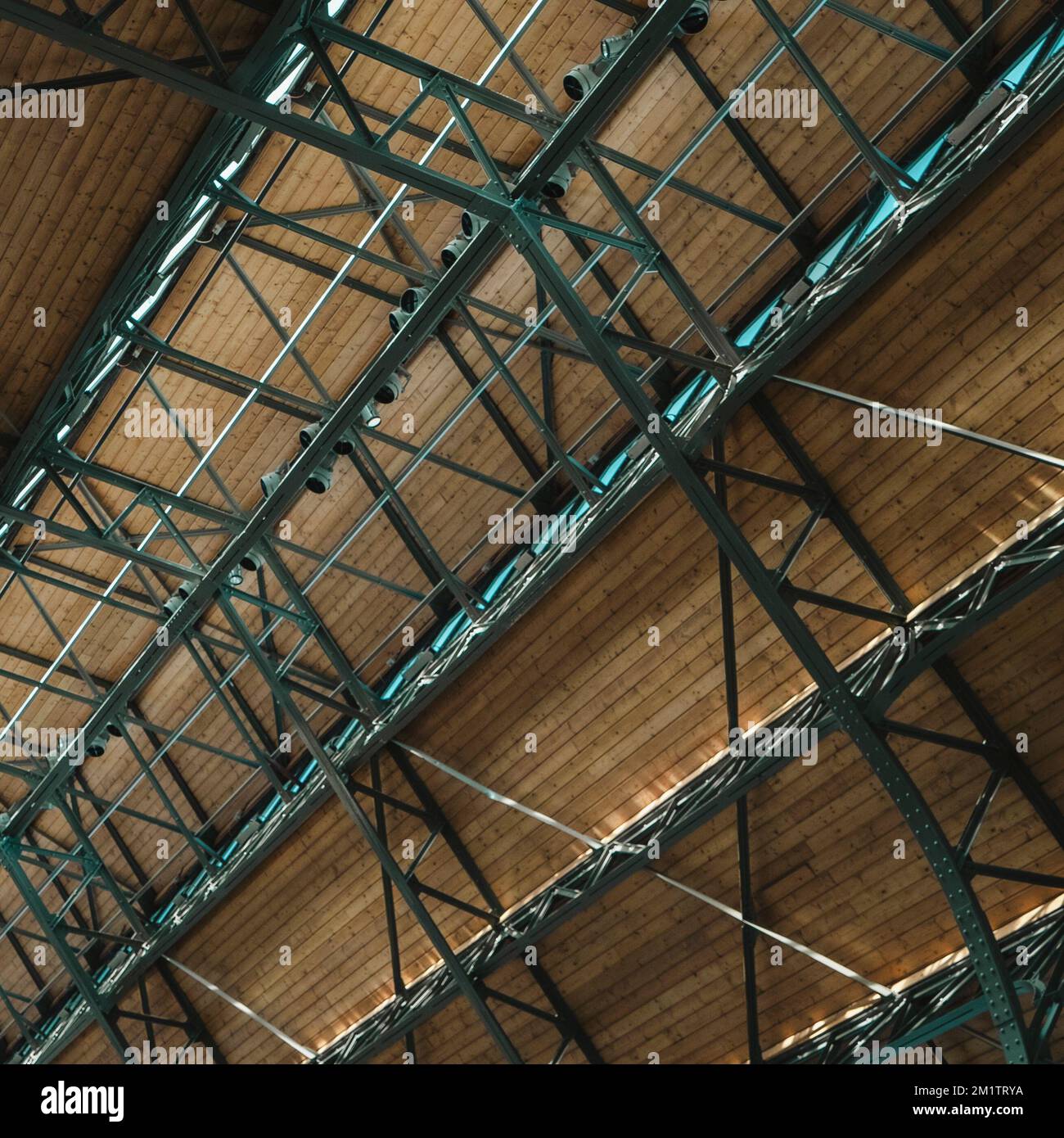A ceiling of a rural barn with a metal structure and wooden surface ...