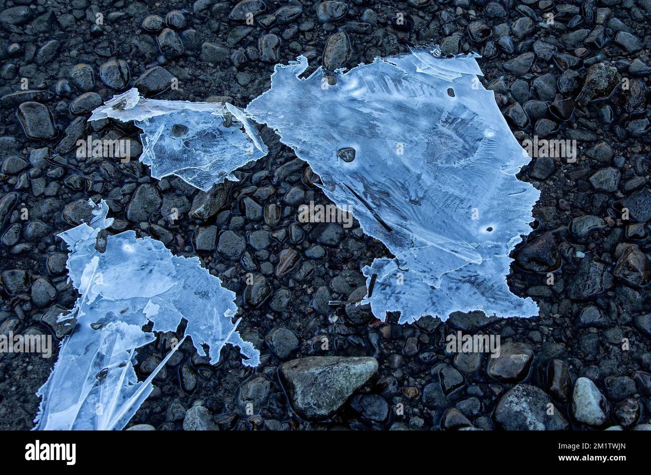 Dry ice on pebbles at the side of a lake Stock Photo - Alamy
