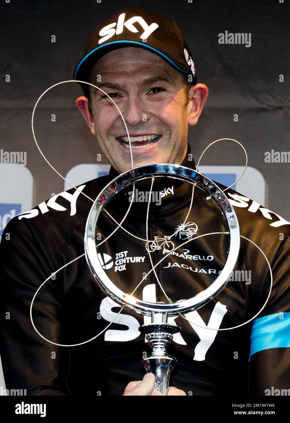 Winner British Ian Stannard of Team Sky poses with his trophy on the ...