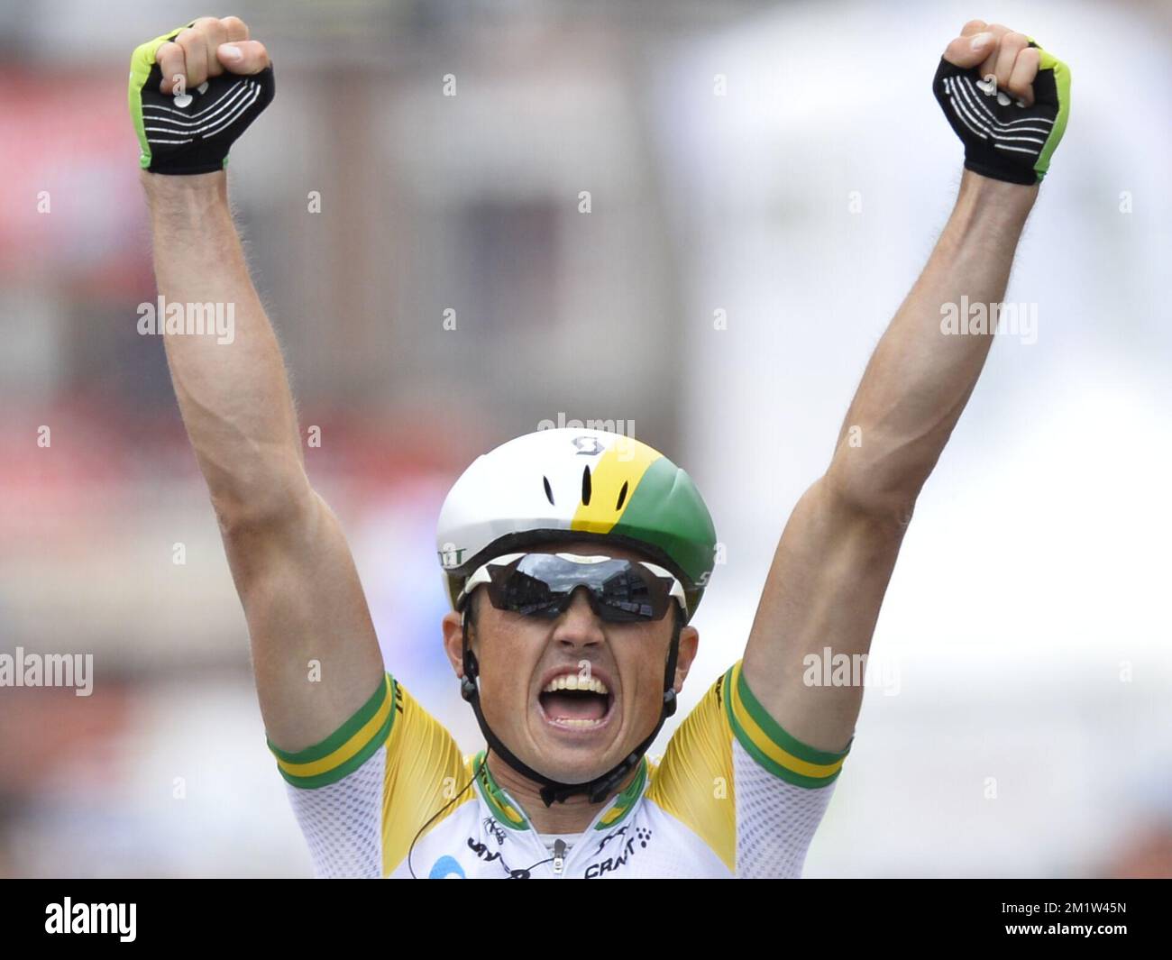 Australian Simon Gerrans of Orica GreenEDGE celebrates with arms up as ...