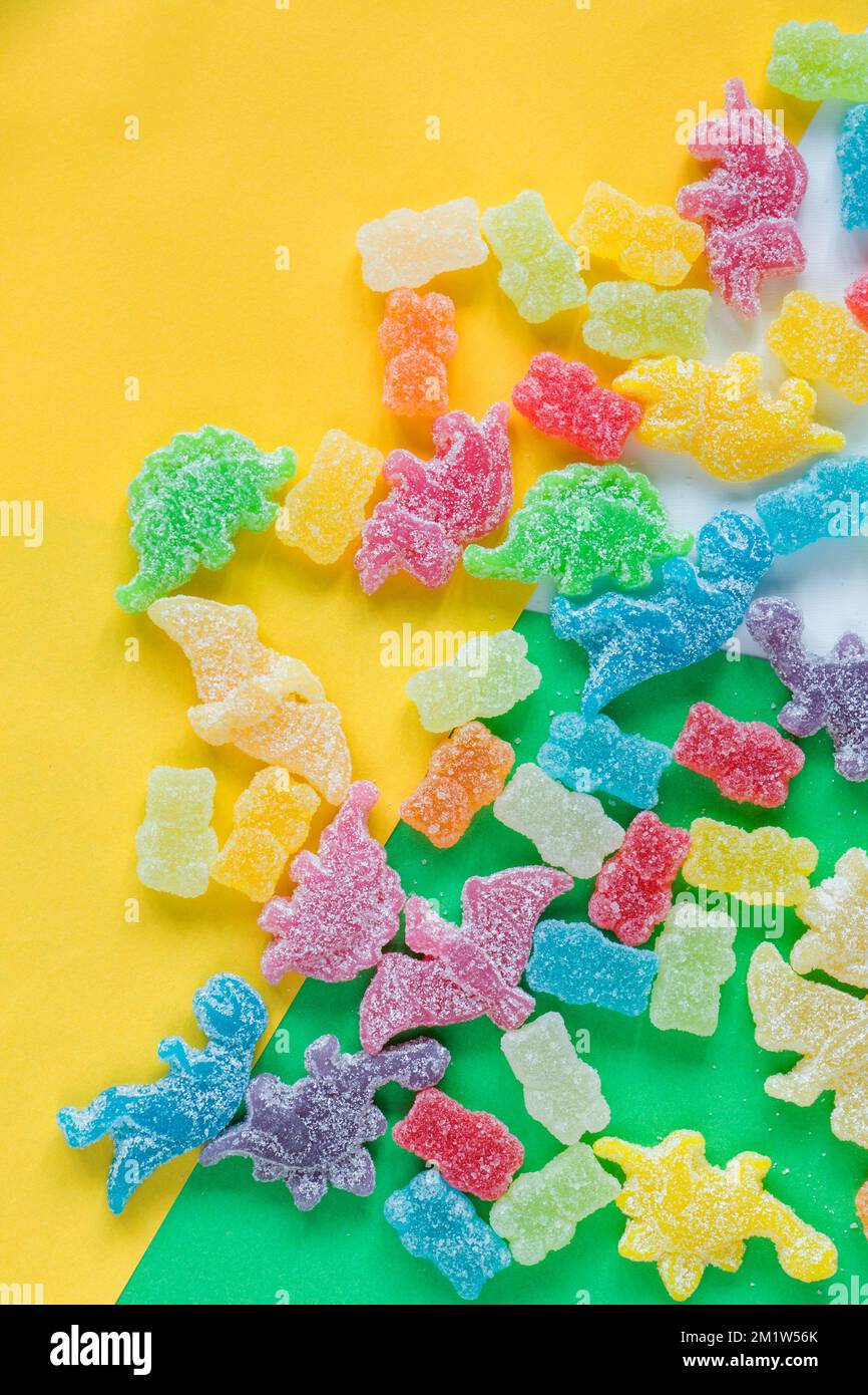 A vertical flat lay shot of colorful gummy candies in the shape of a ...