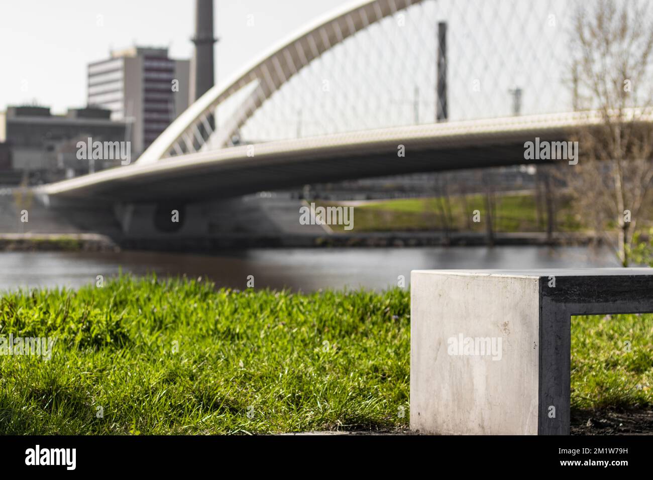 A bench with the Troja bridge in the blurred background in Prague ...