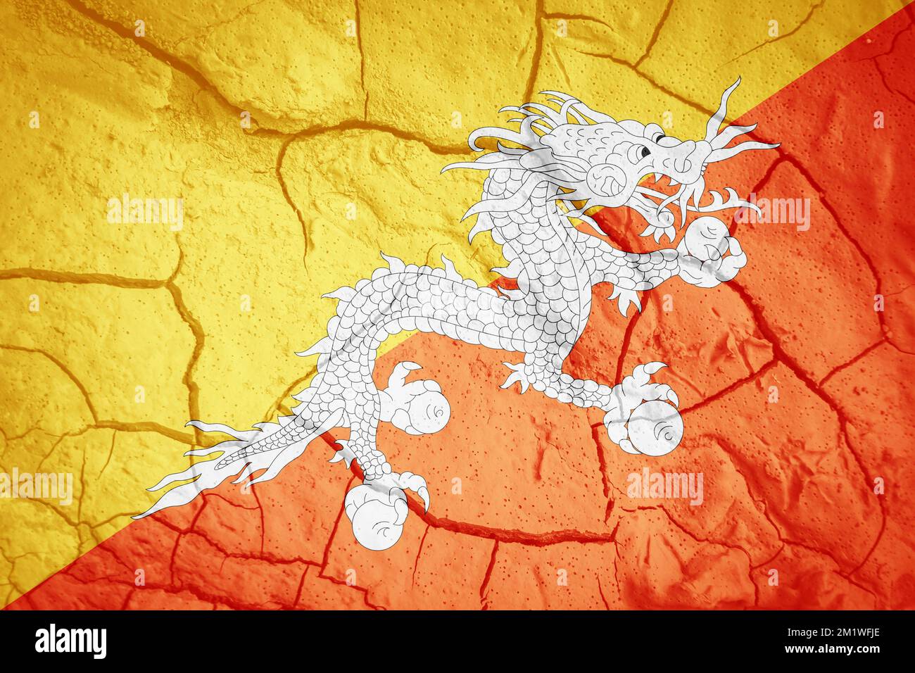 Flag of Bhutan. Bhutanese symbol. Flag on the background of dry cracked ...