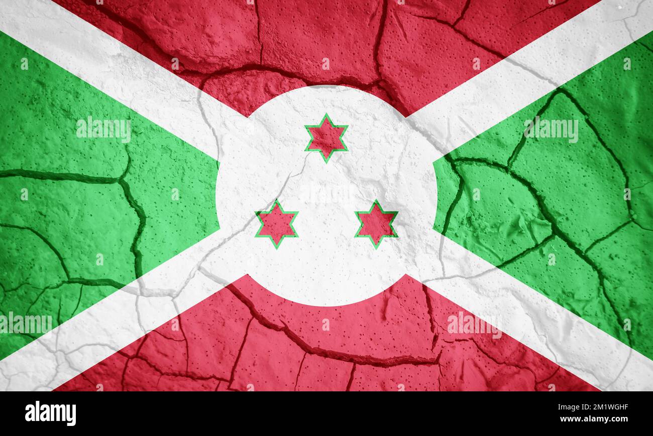 Flag of Burundi. Burundi symbol. Flag on the background of dry cracked ...