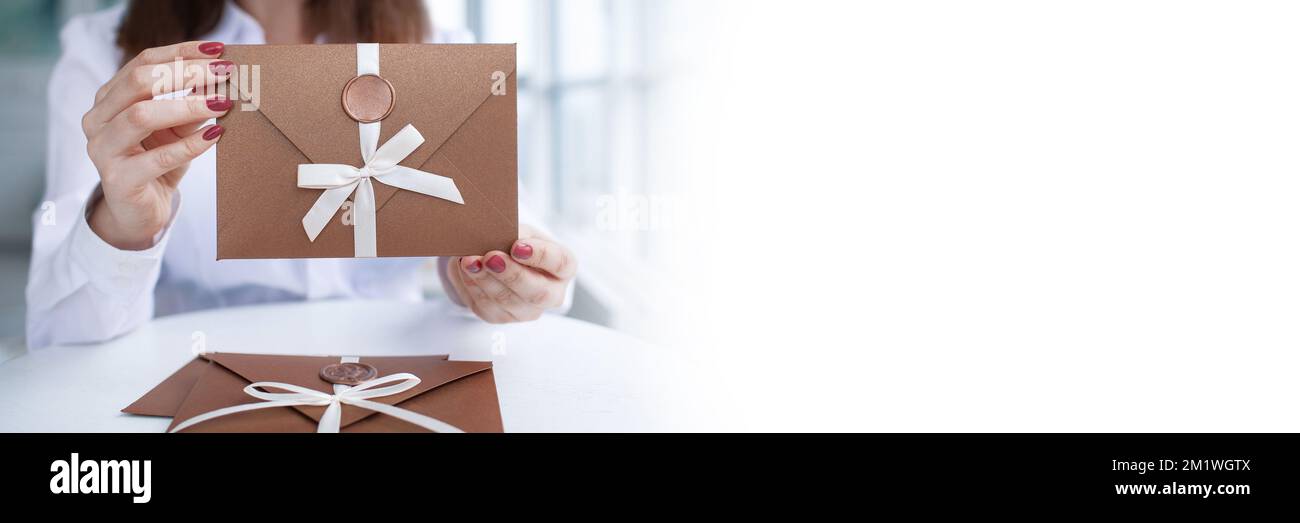 bronze envelope with wax seal and bow as wedding invitation card on ...