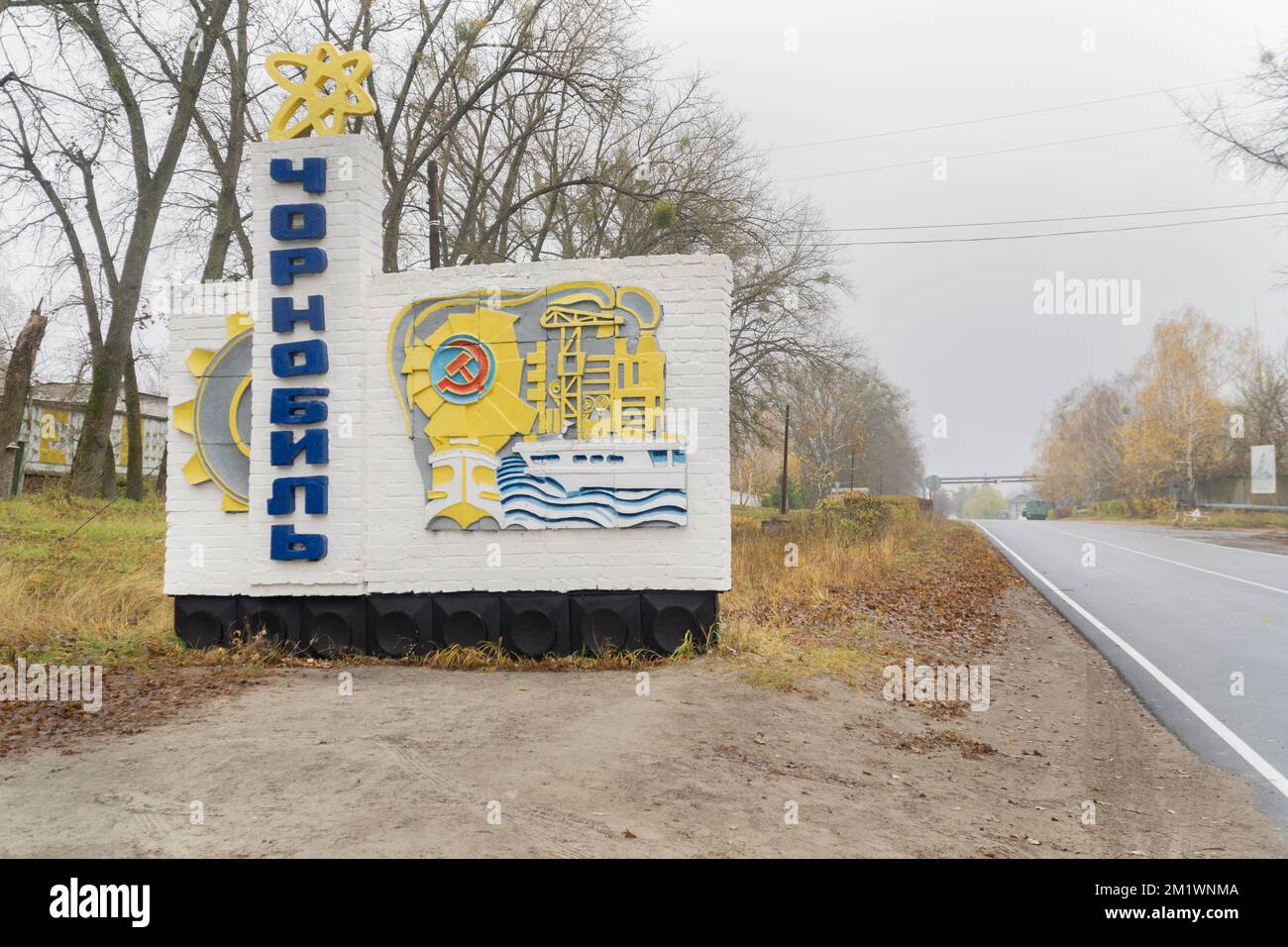 Chernobyl town lettering sign entrance near to a road with cloudy sky ...