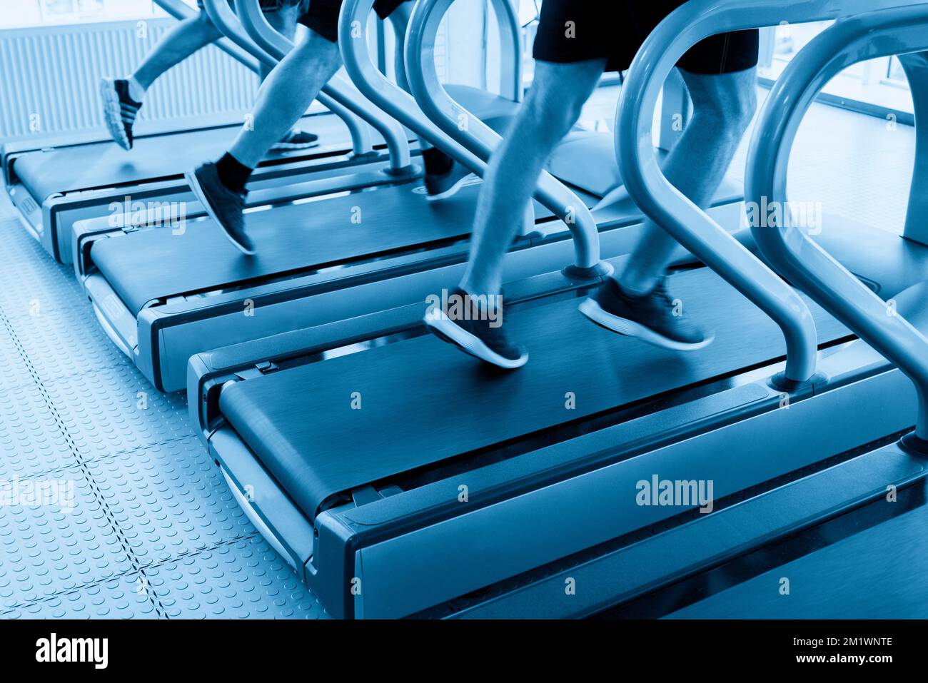 gym shot - people running on machines, treadmill with motion blur Stock ...