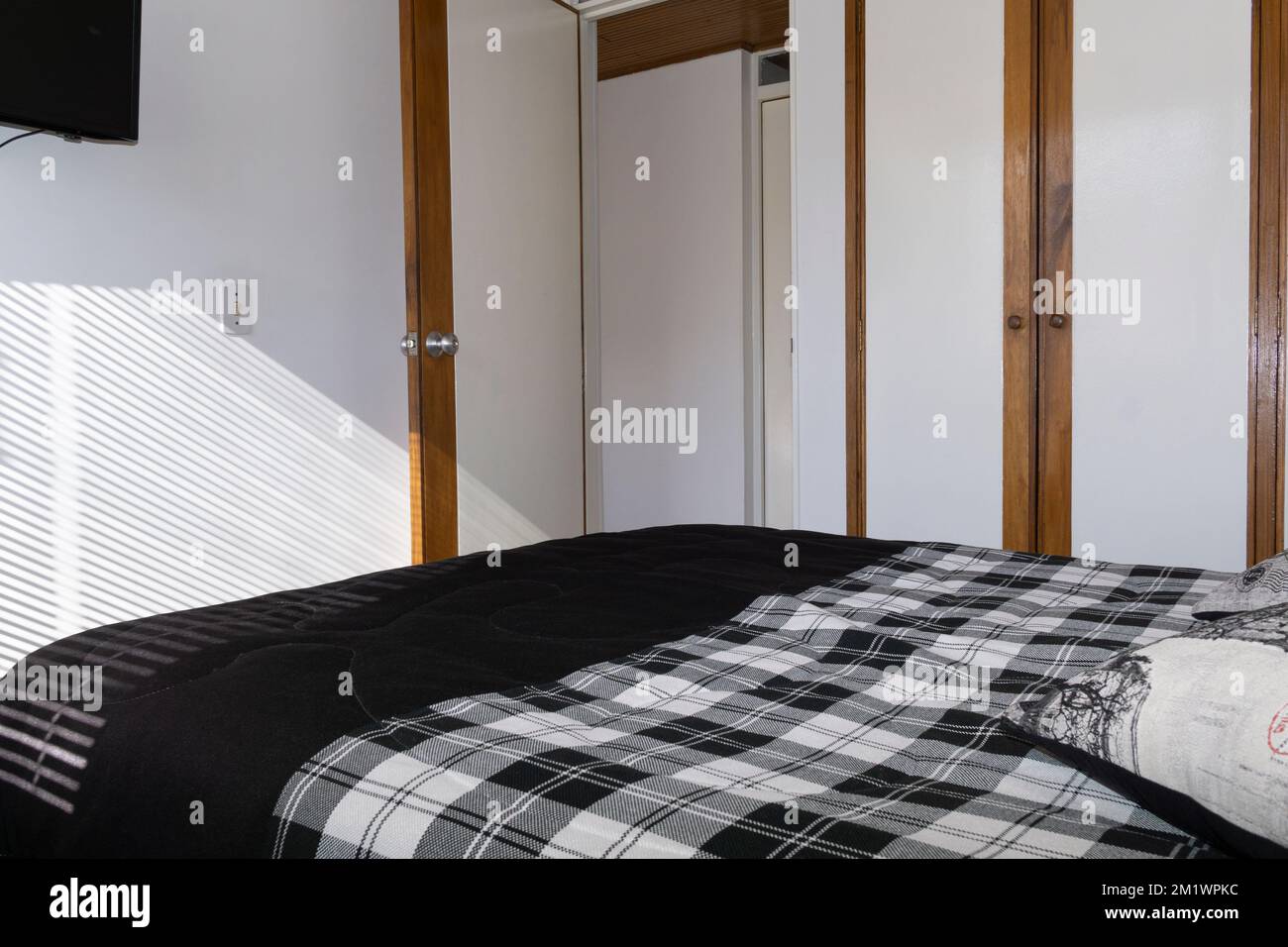 dark blue and white geometric duvet inside a minimalist interior design ...