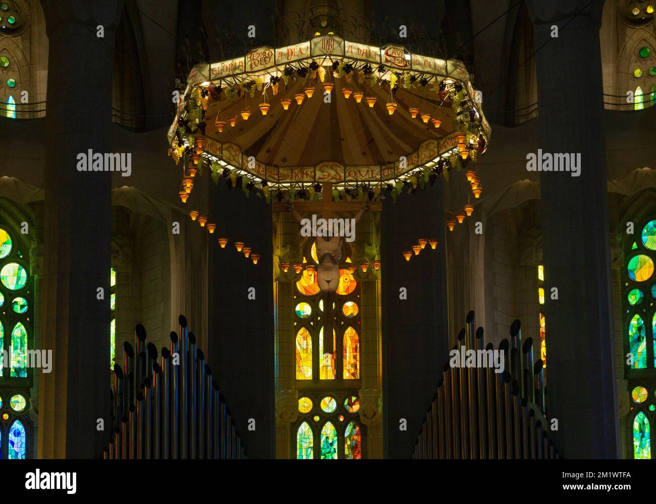 Sagrada Familia cathedral Jesus christ crucified statue with beautiful stained glass and steel ...