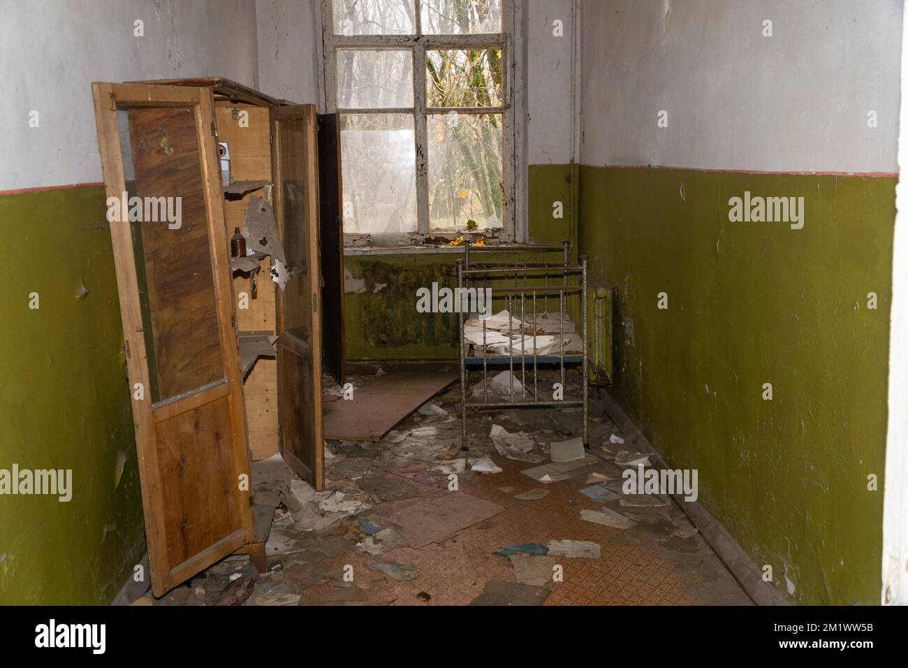 Destroyed wooden furniture and rusty kid bed inside abandonated room at ...