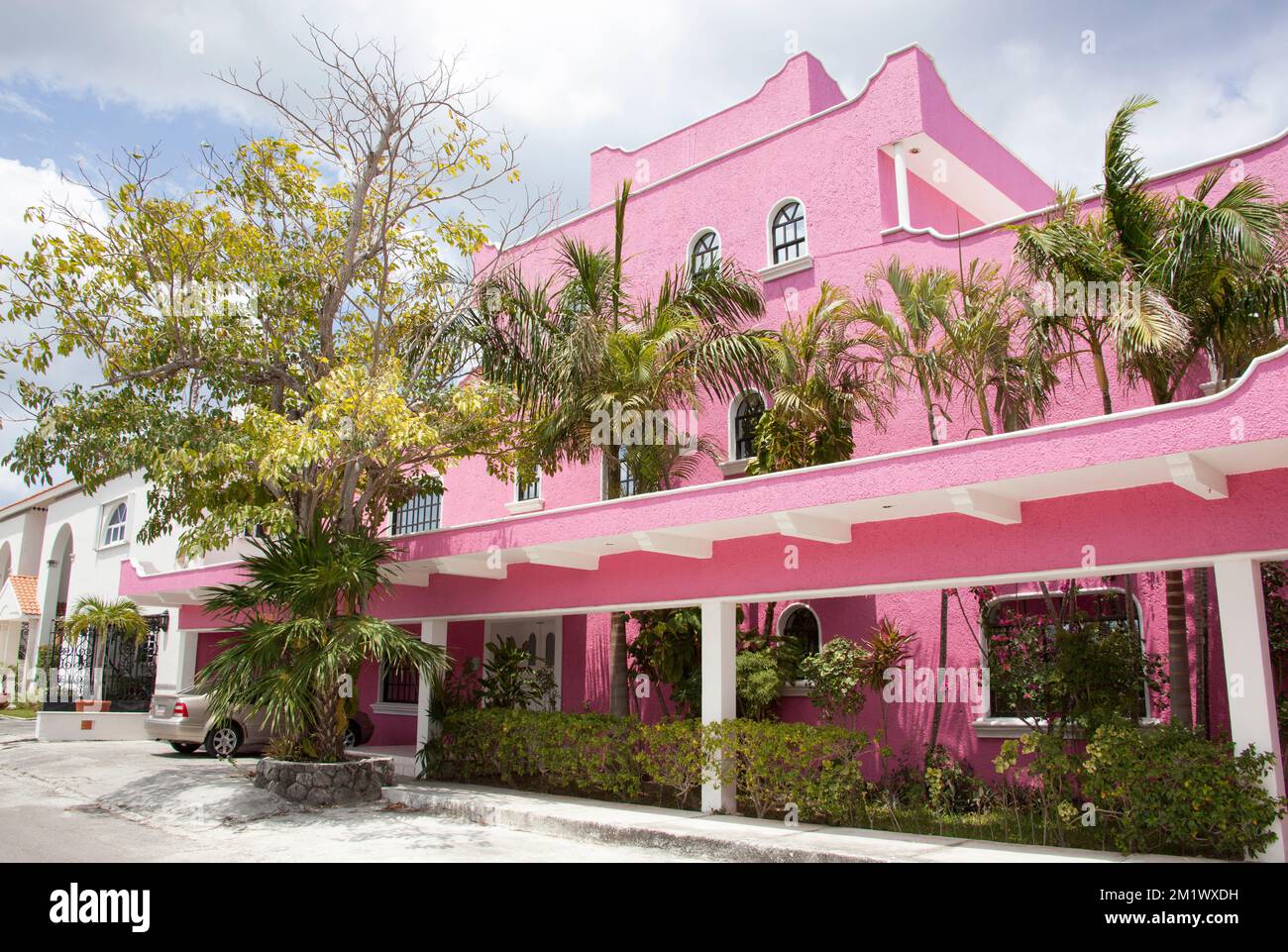 The bright pink color residential house on a main street in San Miguel ...