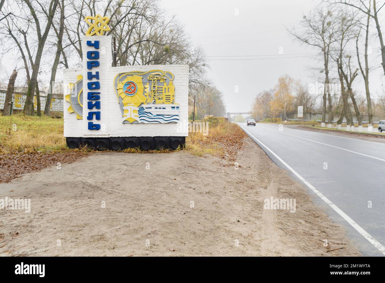 Old lettering chernobyl town entrance sign near to an asphalt road ...
