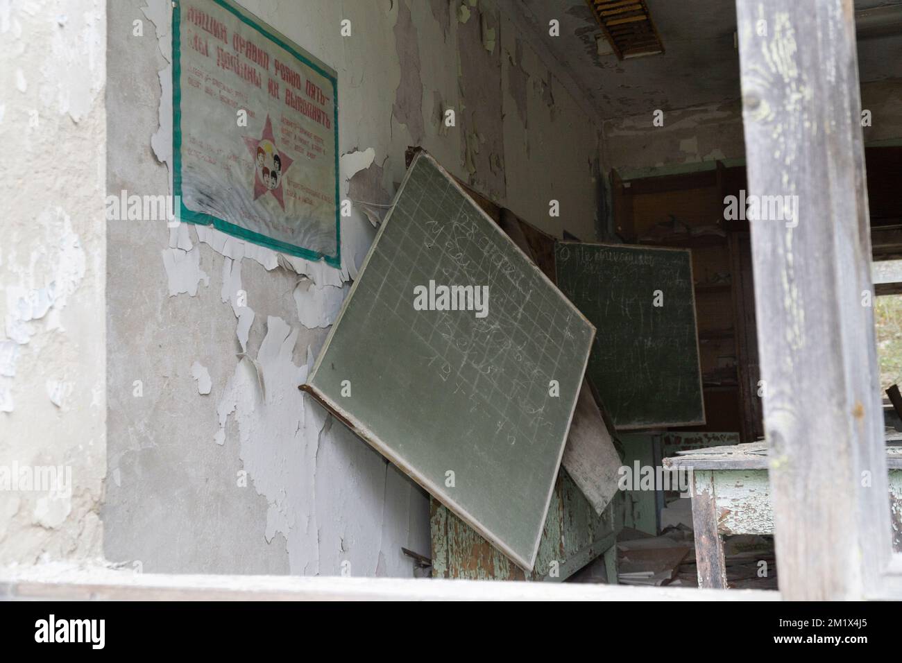 An old destroyed blackboard inside an abandonated school at chernobyl ...