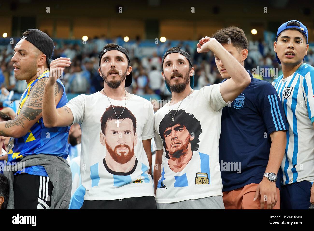 A set of twins wearing shirts featuring Argentina's Lionel Messi and ...