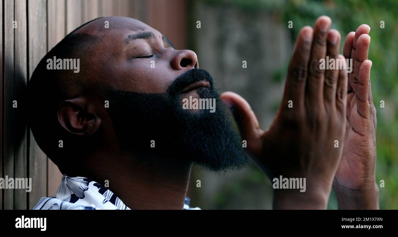 African man praying to God, person asking for divine help, begging for ...