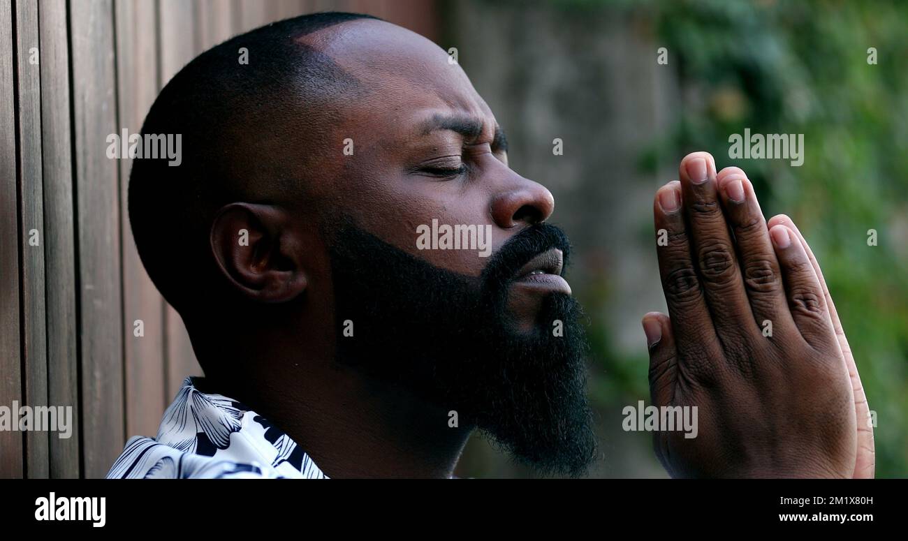 African man praying to God, person asking for divine help, begging for ...