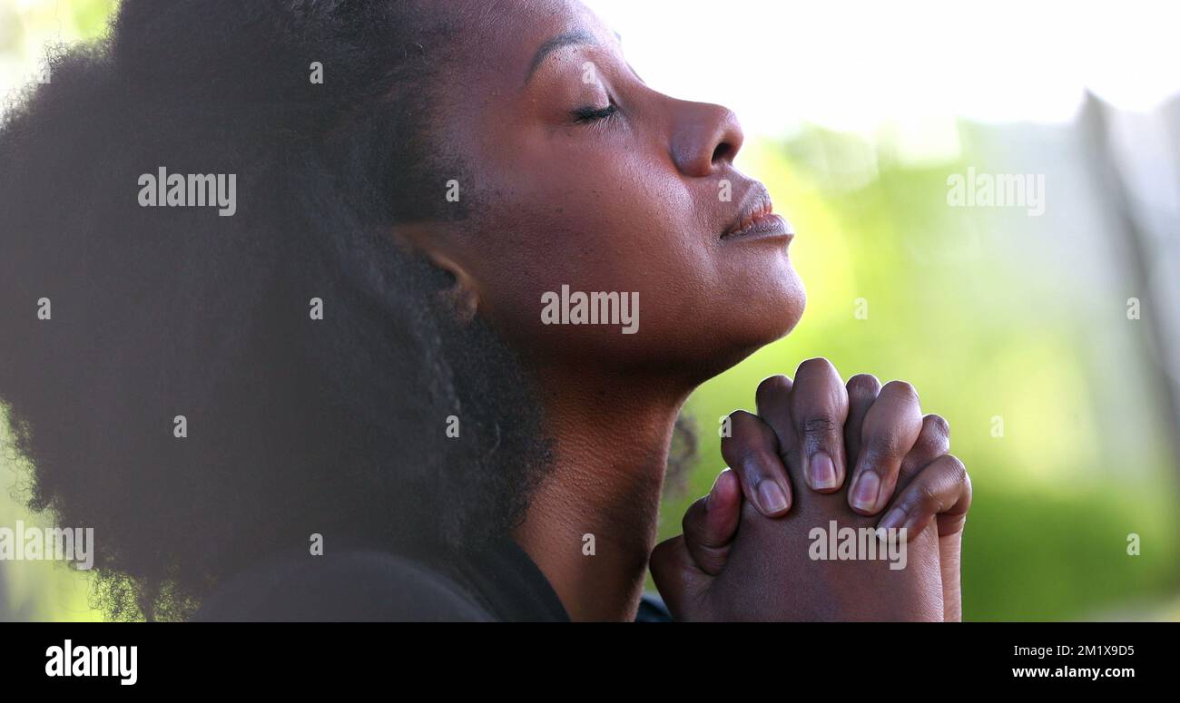 African woman praying to God seeking divine help, asking for support ...