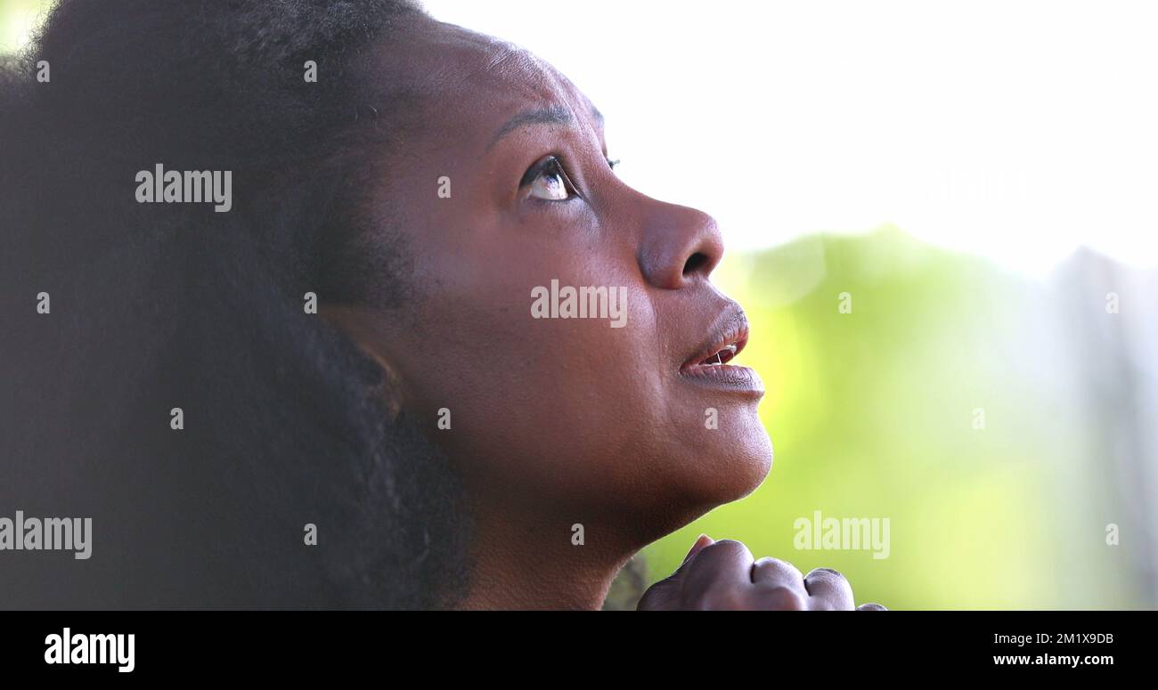 African woman praying to God seeking divine help, asking for support ...