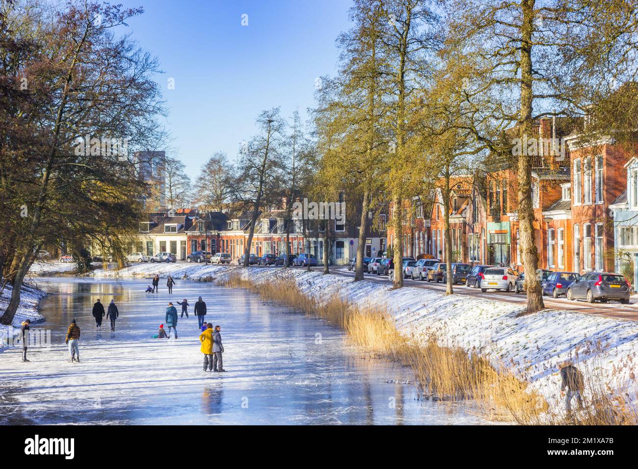 People skating on the canal in the historic city Groningen, Netherlands ...