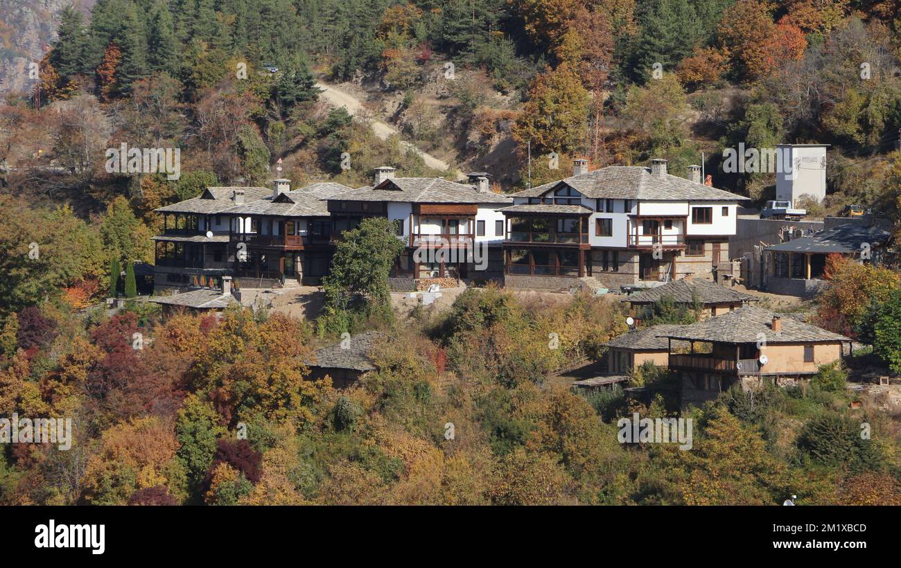 The old countryside houses at a small village surrounded by trees on a ...
