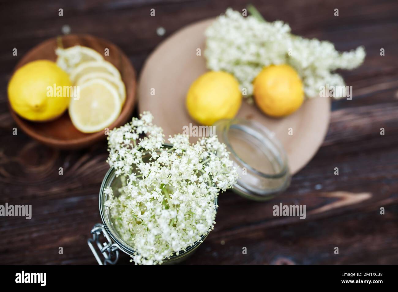 Grinding lemon and black elderberry on a cutting board to make an ...