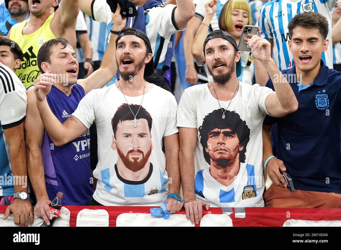 A set of twins wearing shirts featuring Argentina's Lionel Messi and ...