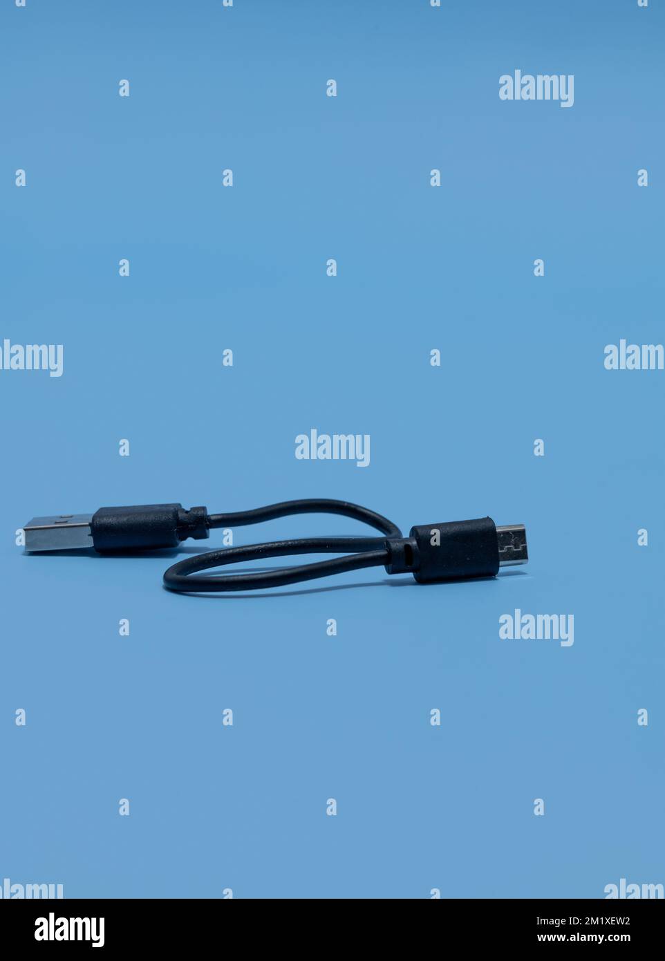 A vertical shot of type A to Micro USB cable on a blue background Stock ...