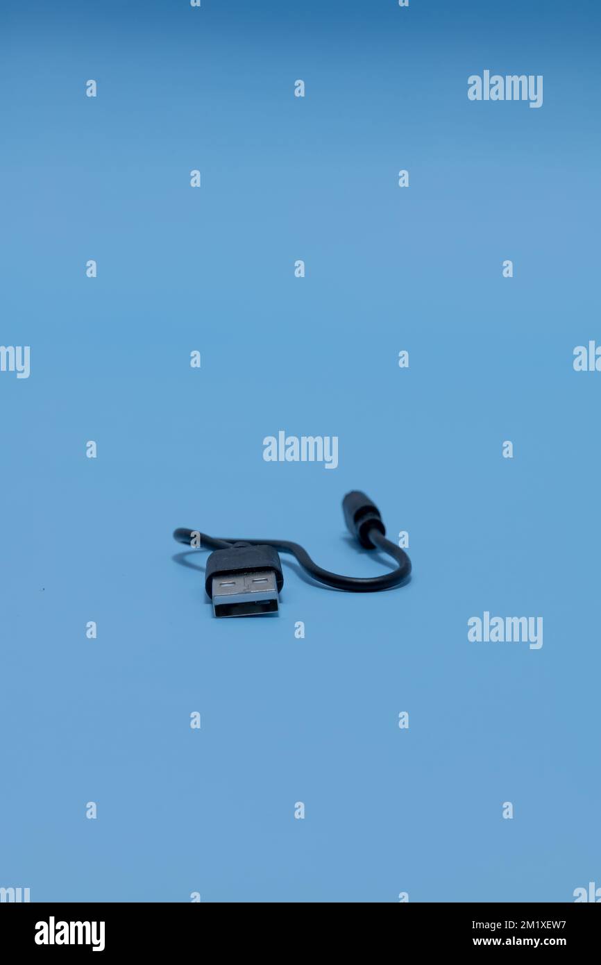 A vertical shot of type A to Micro USB cable on a blue background Stock ...