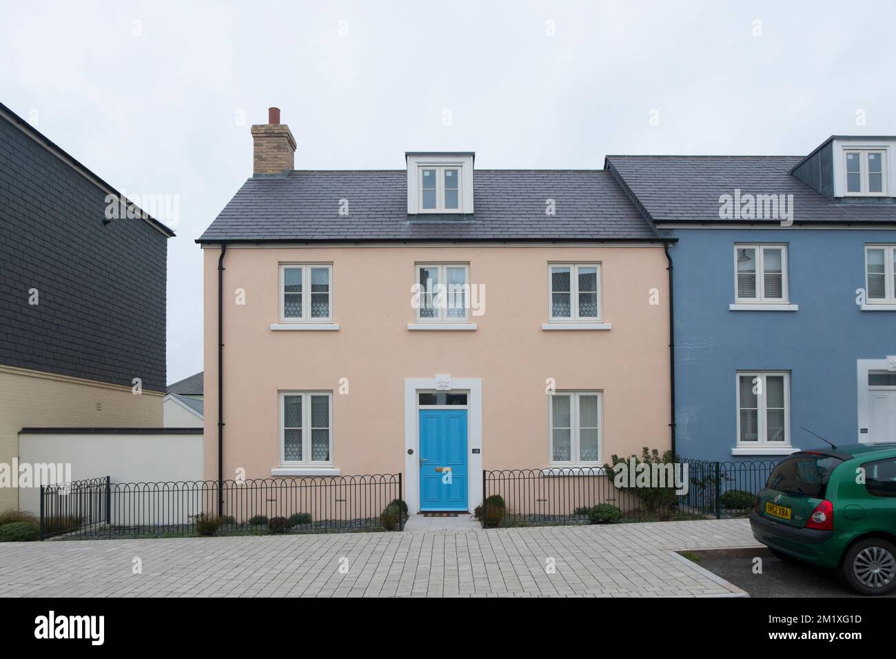 Blue & peach three storey, semi-detached houses on Stret Kosti Veur ...