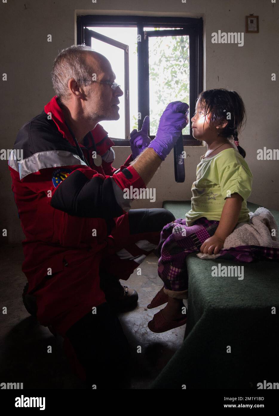 20150430 - GORKHA, NEPAL: A B-Fast team takes care of a local child, an ...